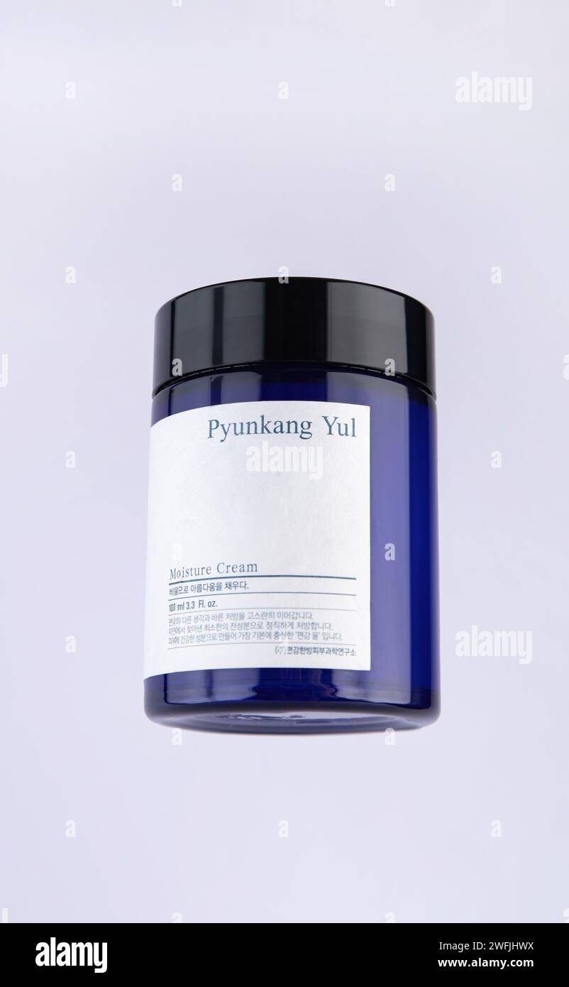 Pyunkang Yul brand moisturizing cream in a blue glass bottle levitates ...
