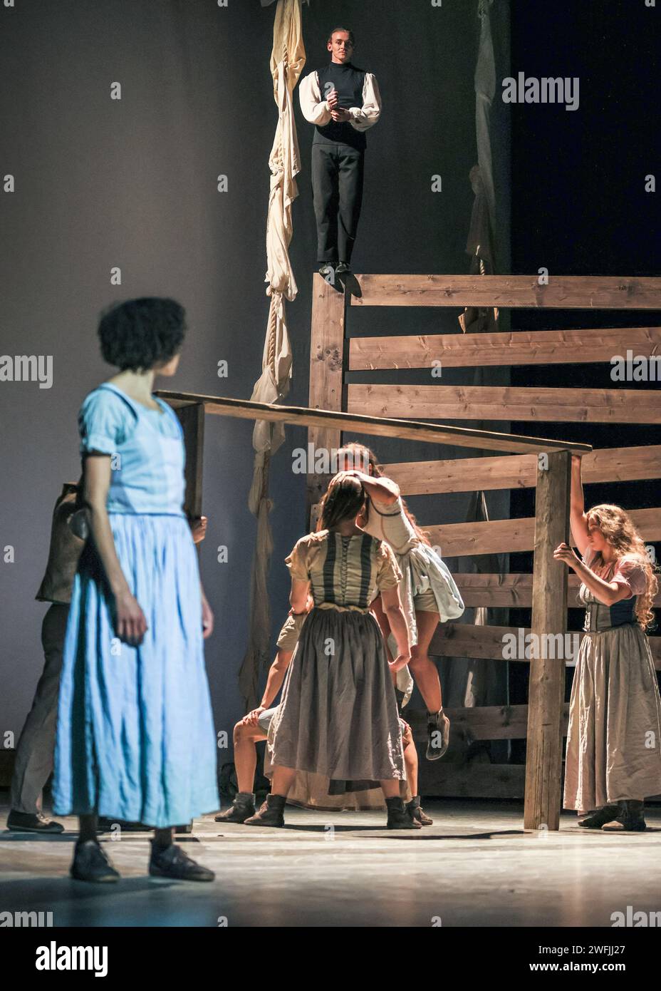 London, UK. 31st Jan, 2024. The ensemble of performers in a scene ...