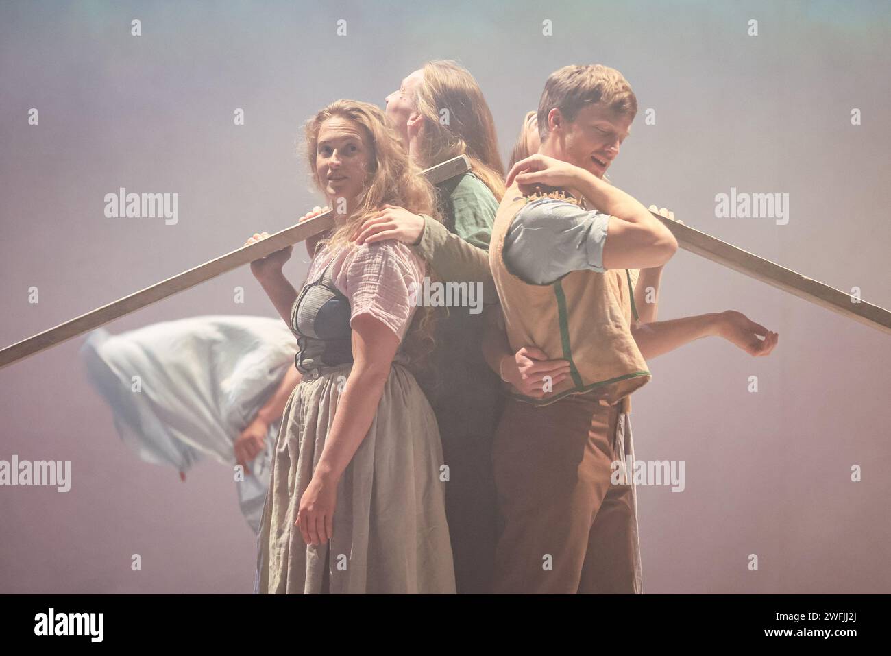 London, UK. 31st Jan, 2024. The ensemble of performers in a scene ...