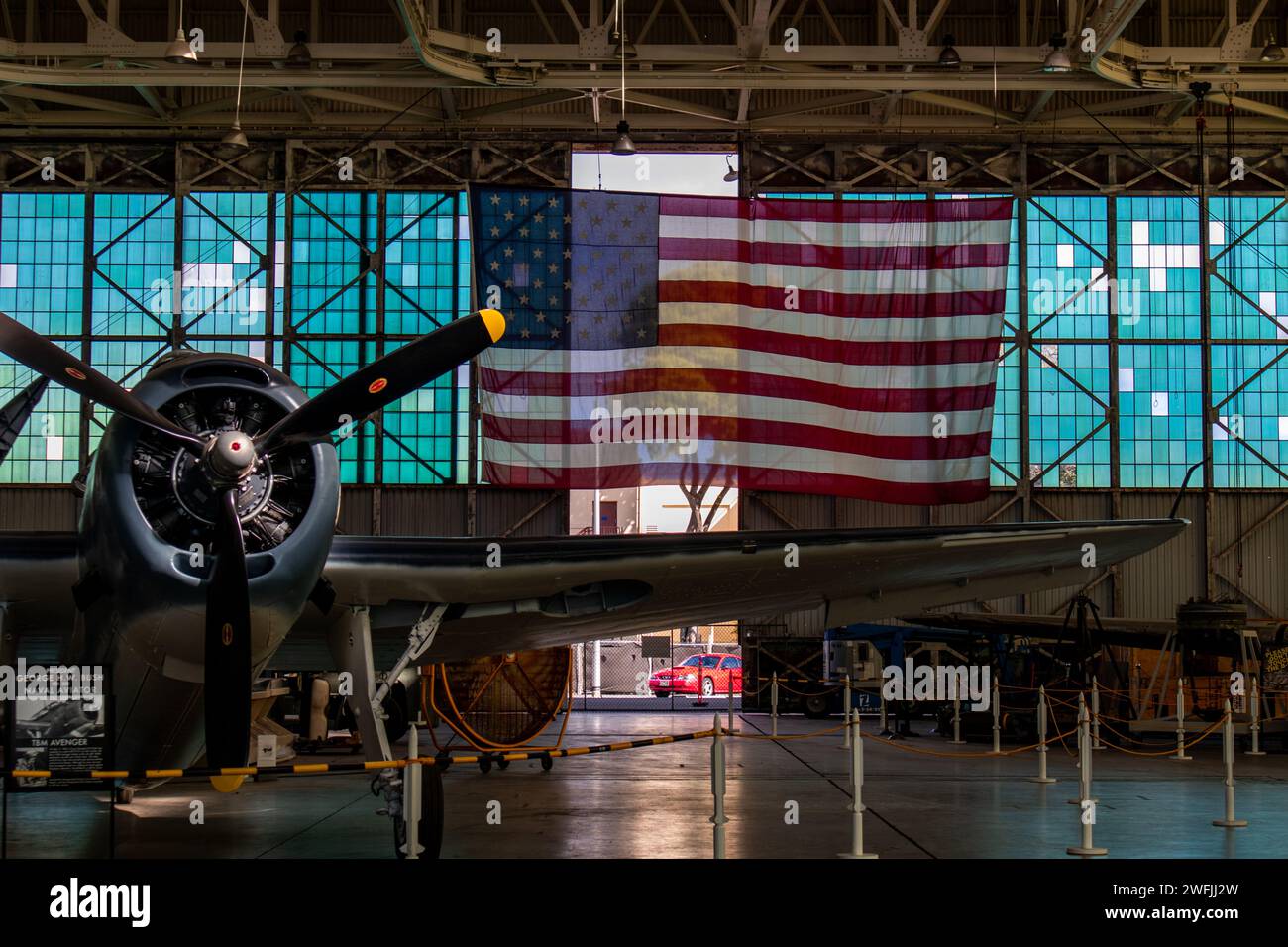 A vintage World War 2 airplane parked inside of an aircraft hanger with ...