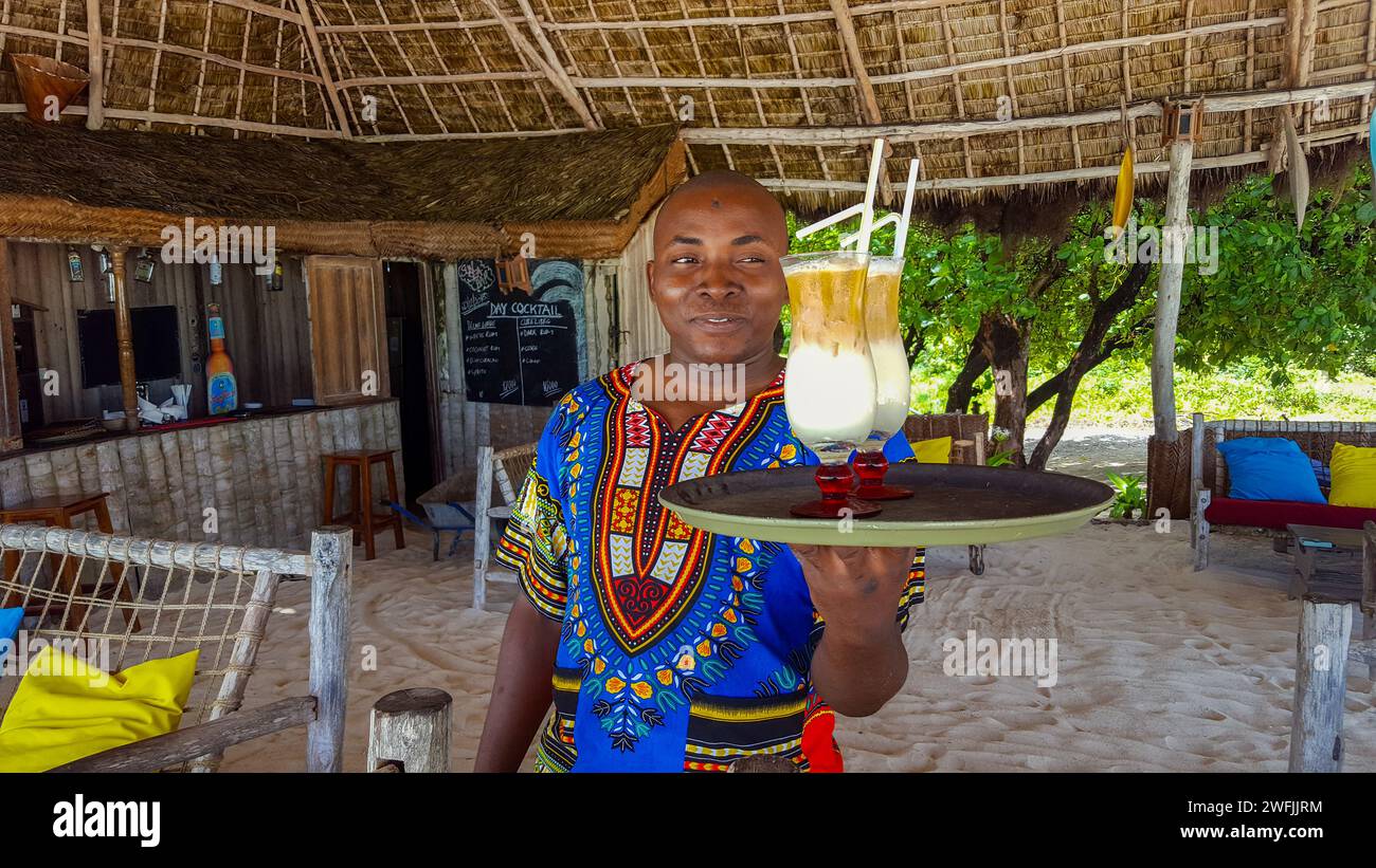 Waiter serving cocktail in the east coast of Zanzibar Stock Photo - Alamy