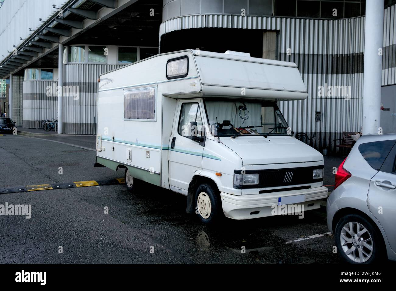 Motor home old 1980's style van parked by the road side in the city ...