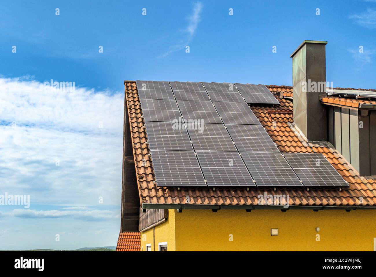 Roof with solar panels against a blue sky Stock Photo - Alamy