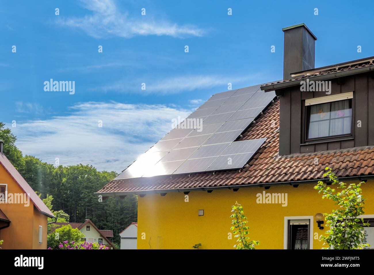 Roof with solar panels against a blue sky Stock Photo - Alamy