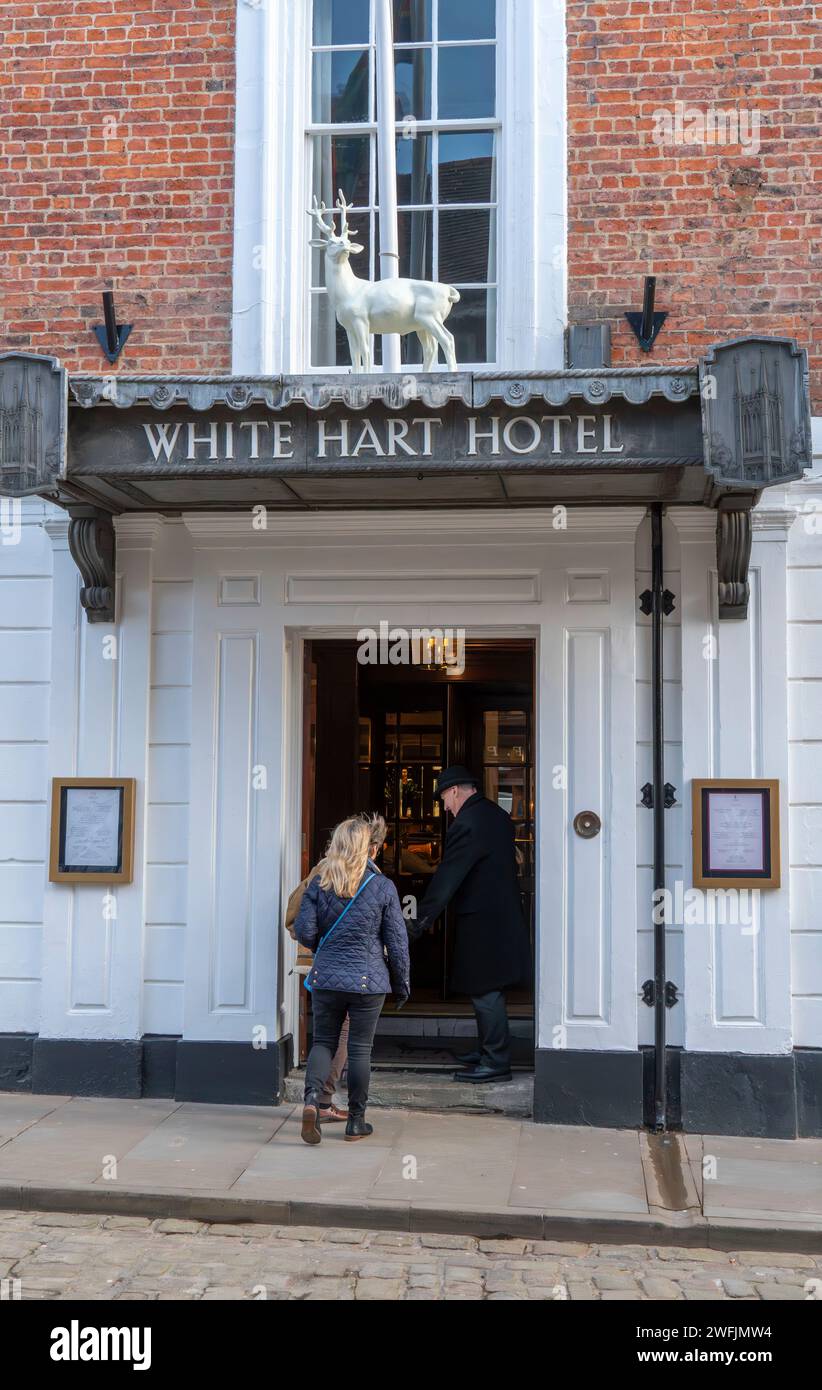 White Hart Hotel commissionaire opening door for people to enter hotel ...