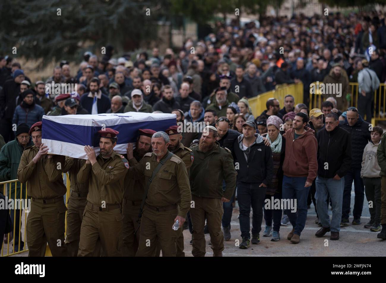 Israeli soldiers carry the flag-draped casket of reservist warrant ...
