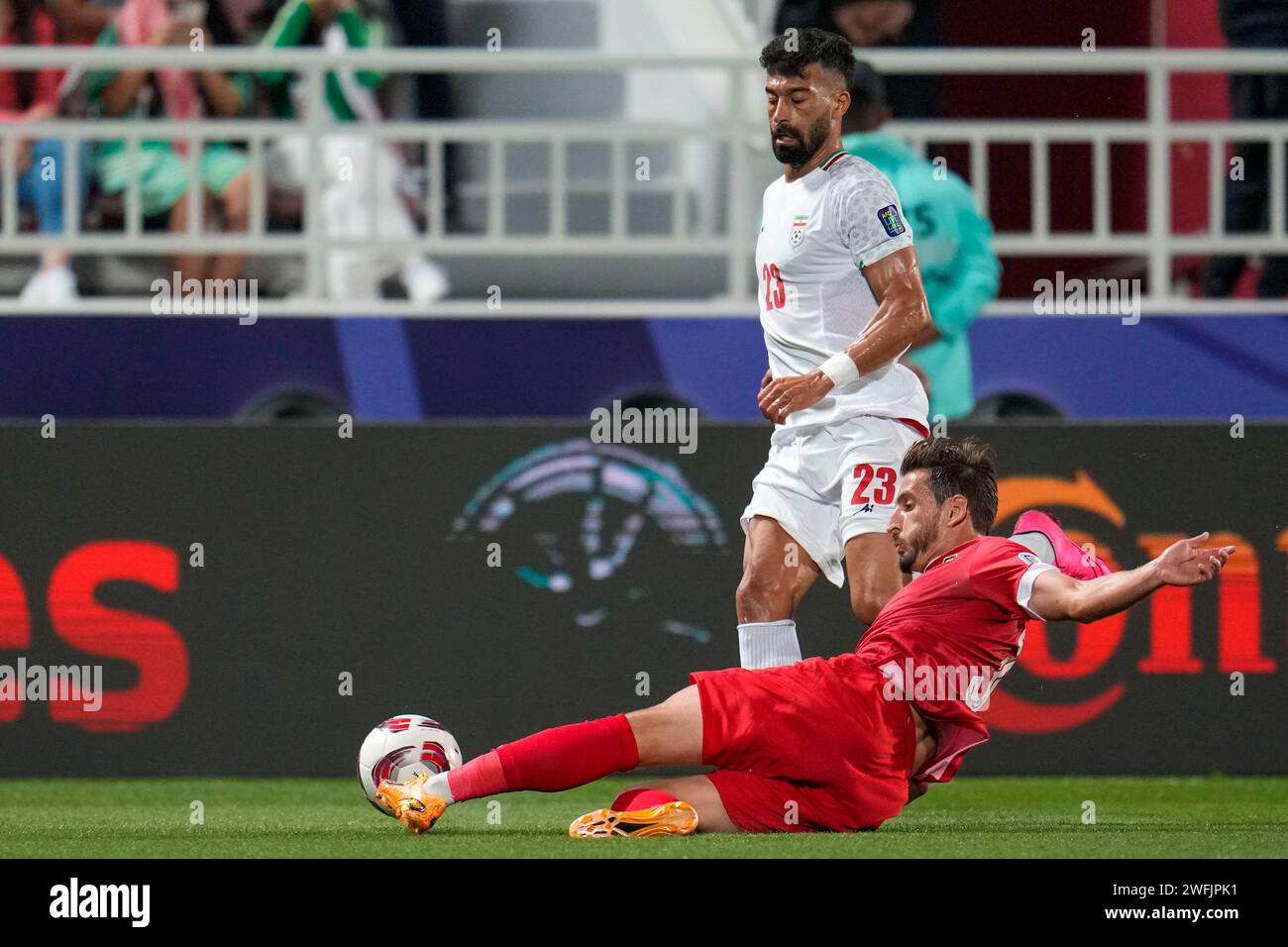 Iran's Ramin Rezaeian, top, duels for the ball with Syria's Mouaiad Al ...