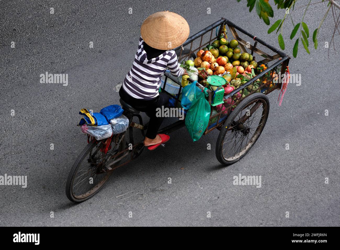Fruit seller riding bicycle Stock Photo - Alamy