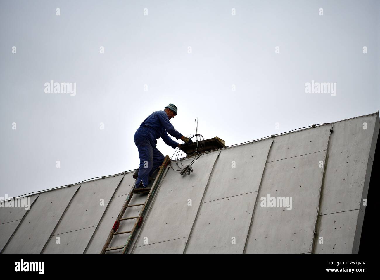 Chimney sweep at work on rooftop hi-res stock photography and images ...