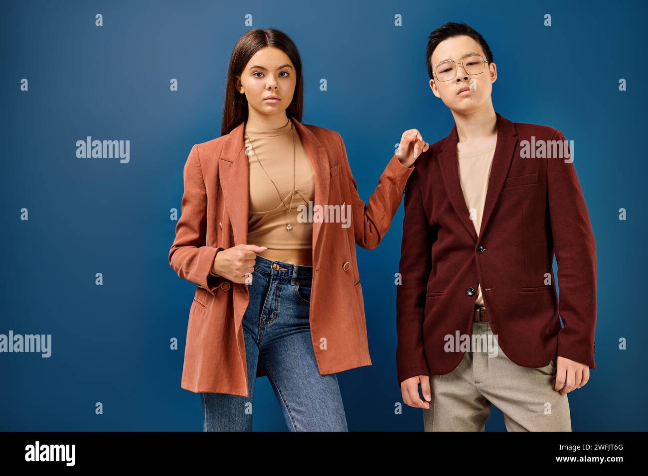 elegant multiracial adolescents in stylish attires posing together on ...