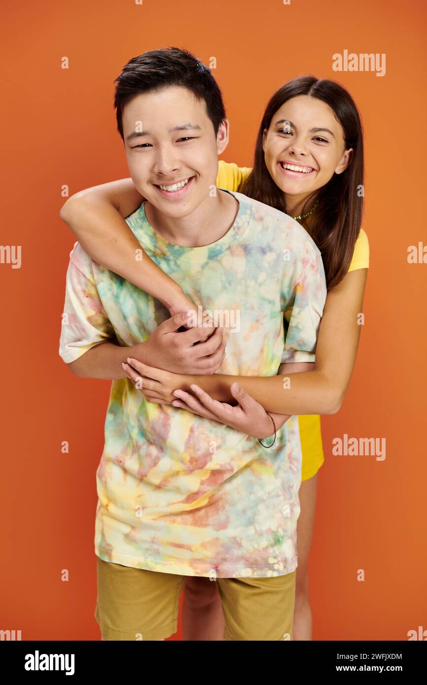 good looking jolly diverse teenage friends hugging and smiling happily ...