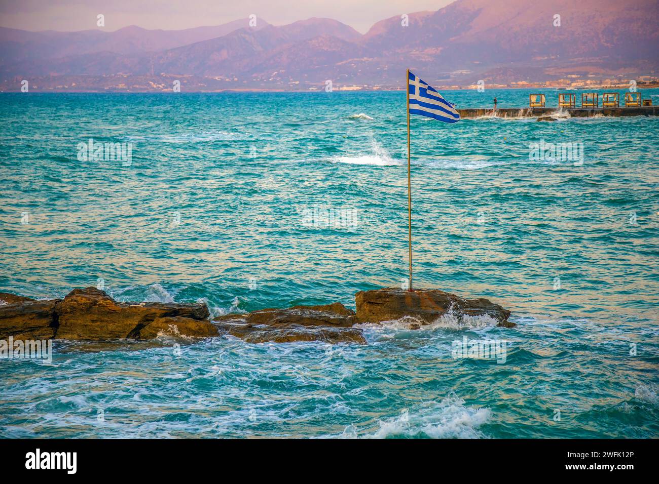 Aegean sea coastline with greek flag in foreground. Romantic beach ...