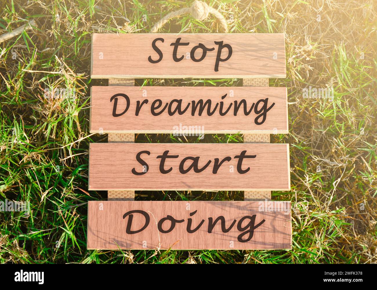 Motivational and inspirational quote on wooden frame - Stop dreaming ...