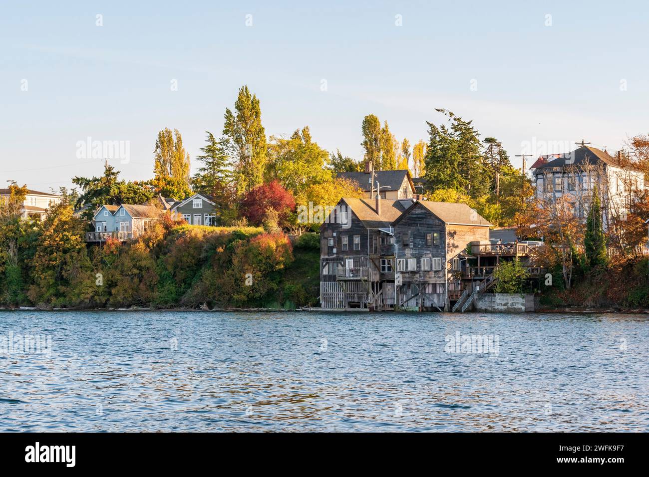 Historic wooden buildings built on pilings, surrounded by colorful ...