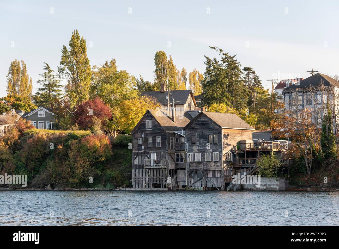 Horizontal photo of shabby old buildings built on pilings in Penn Cove ...