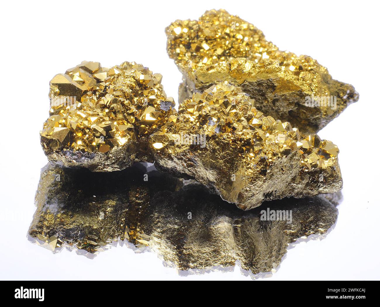 golden stones on the white background on a mirror Stock Photo - Alamy