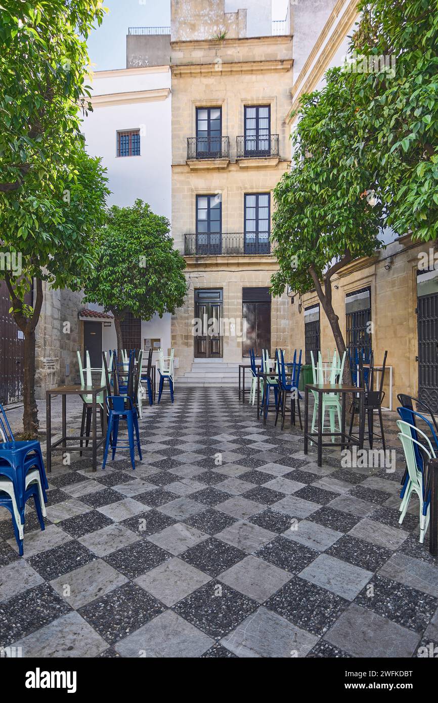 An inviting outdoor cafe with blue chairs on a cobblestone street ...