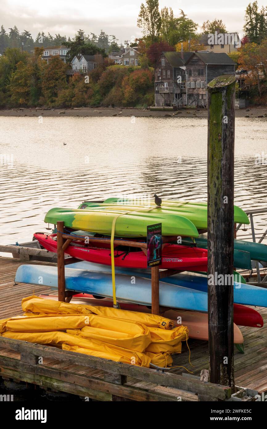 Colorful kayaks are stacked on the dock at the Coupeville Wharf, with ...