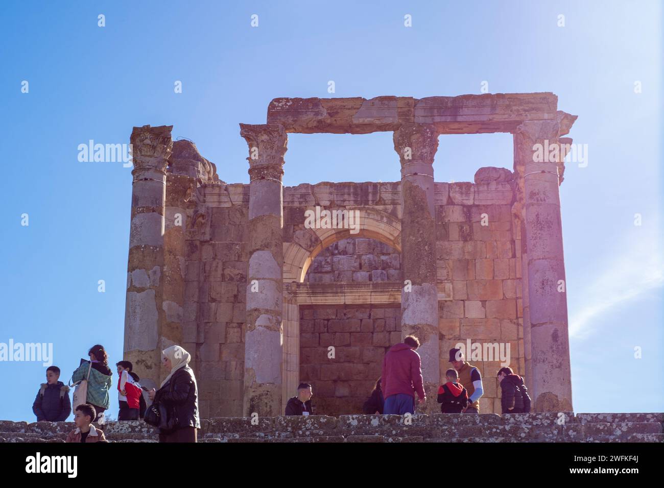 A school class with their teacher on a field trip exploring the ancient ...