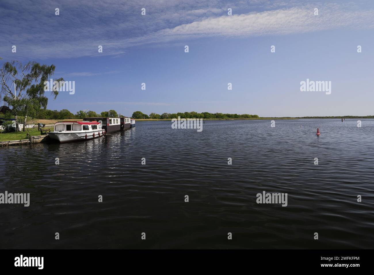 Summer view over boats at Hickling Broad, Norfolk Broads National Park ...