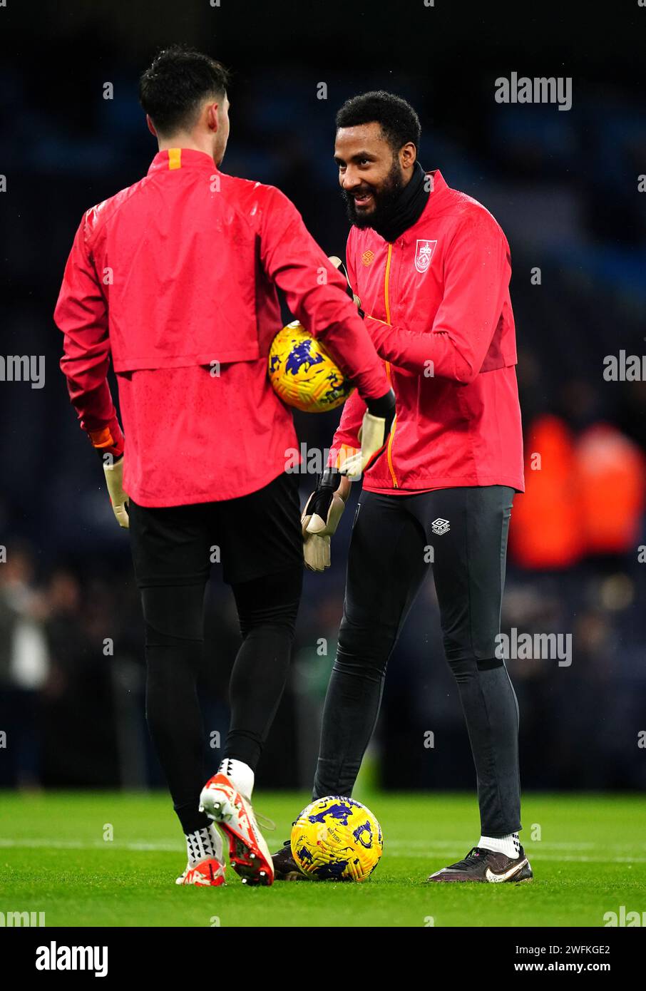 Burnley goalkeeper Lawrence Vigouroux (right) warming up prior to kick ...