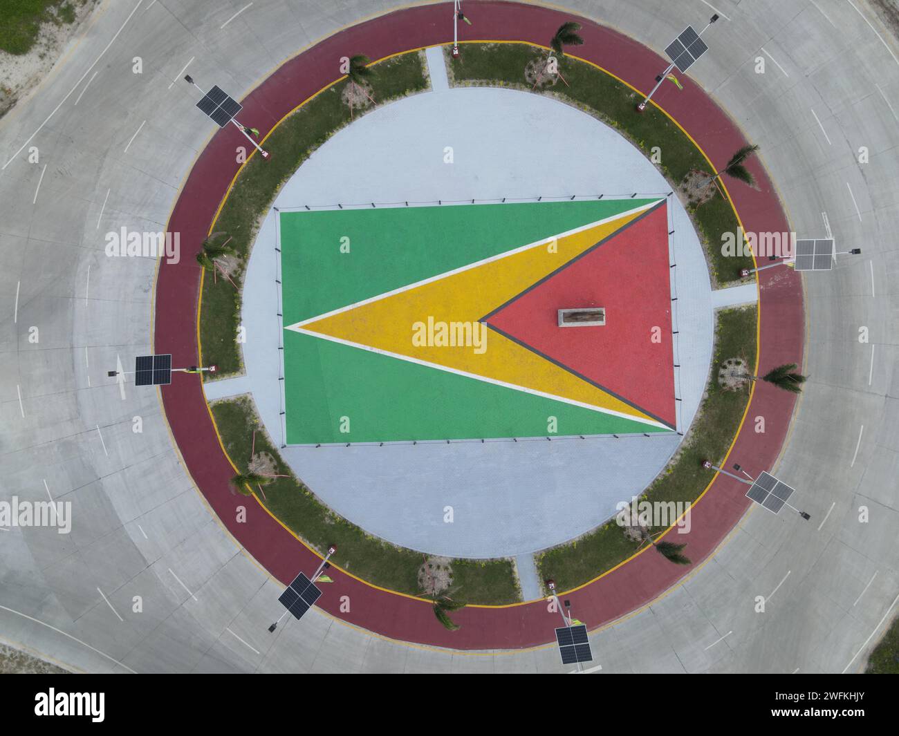 A vibrant circular area on a street with parking spaces, featuring a ...