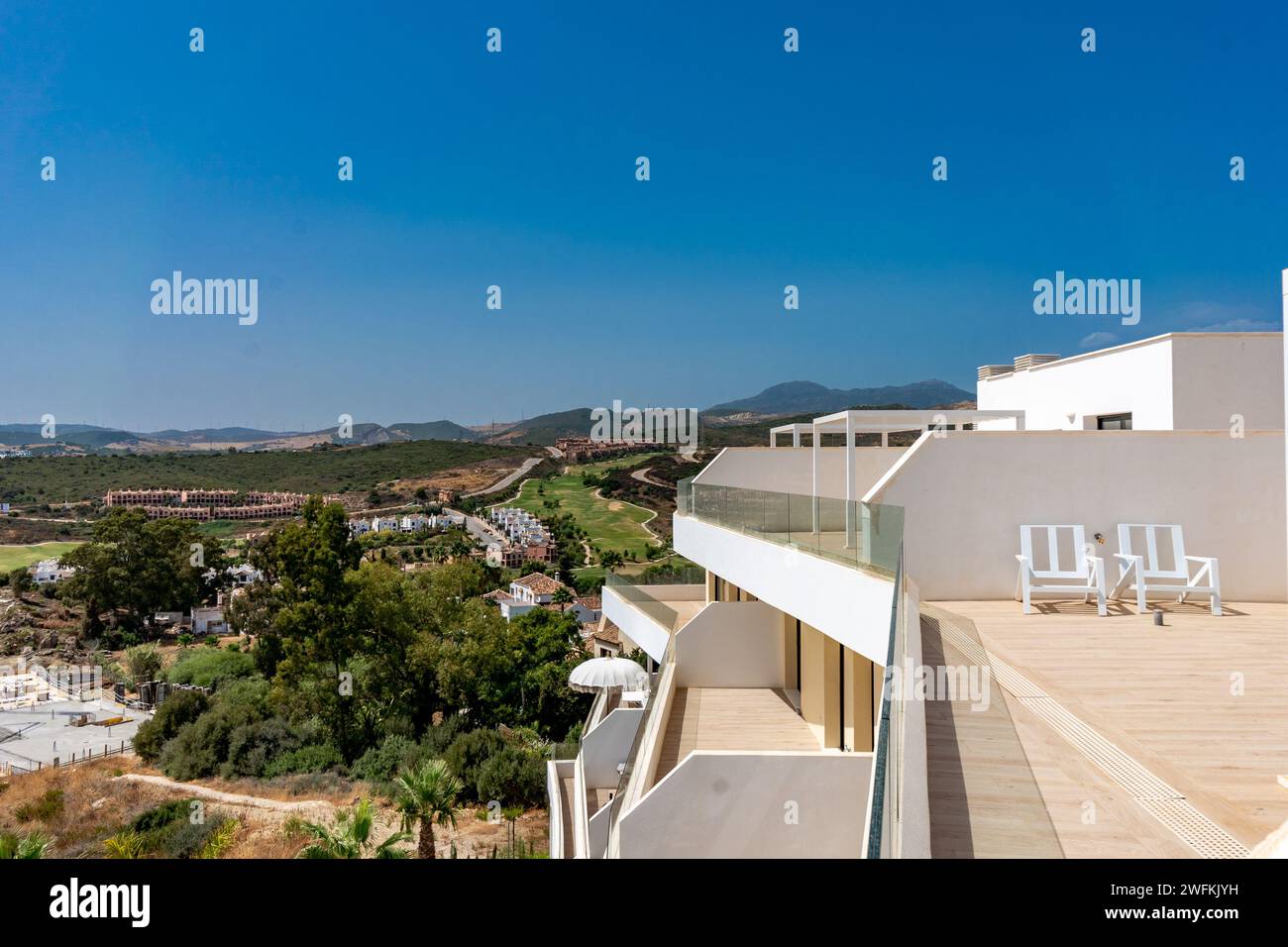 a rooftop terrace with landscape views of mountains of the ...