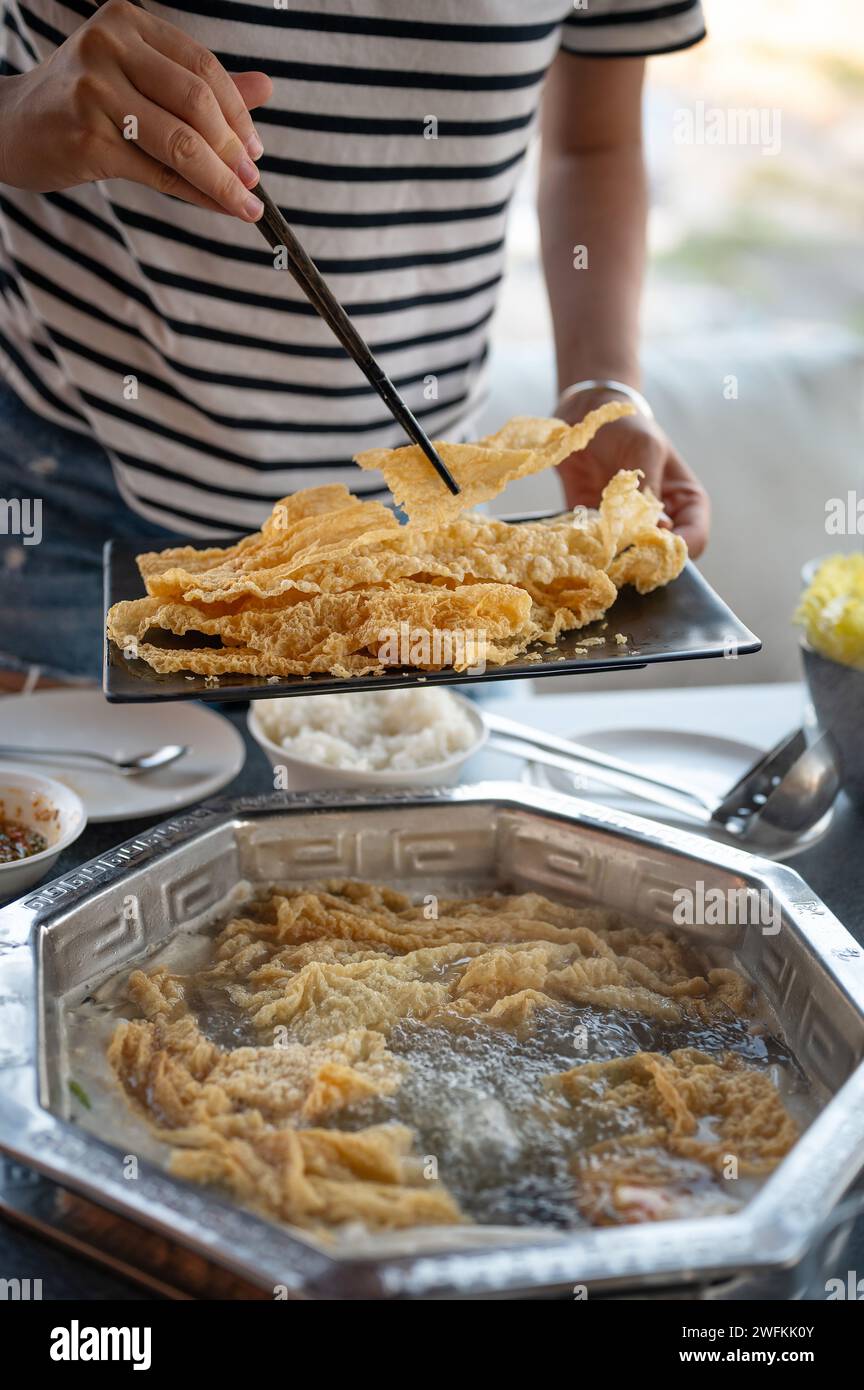 Female person has a hot meal with lots of ingredients to cook in a hot ...