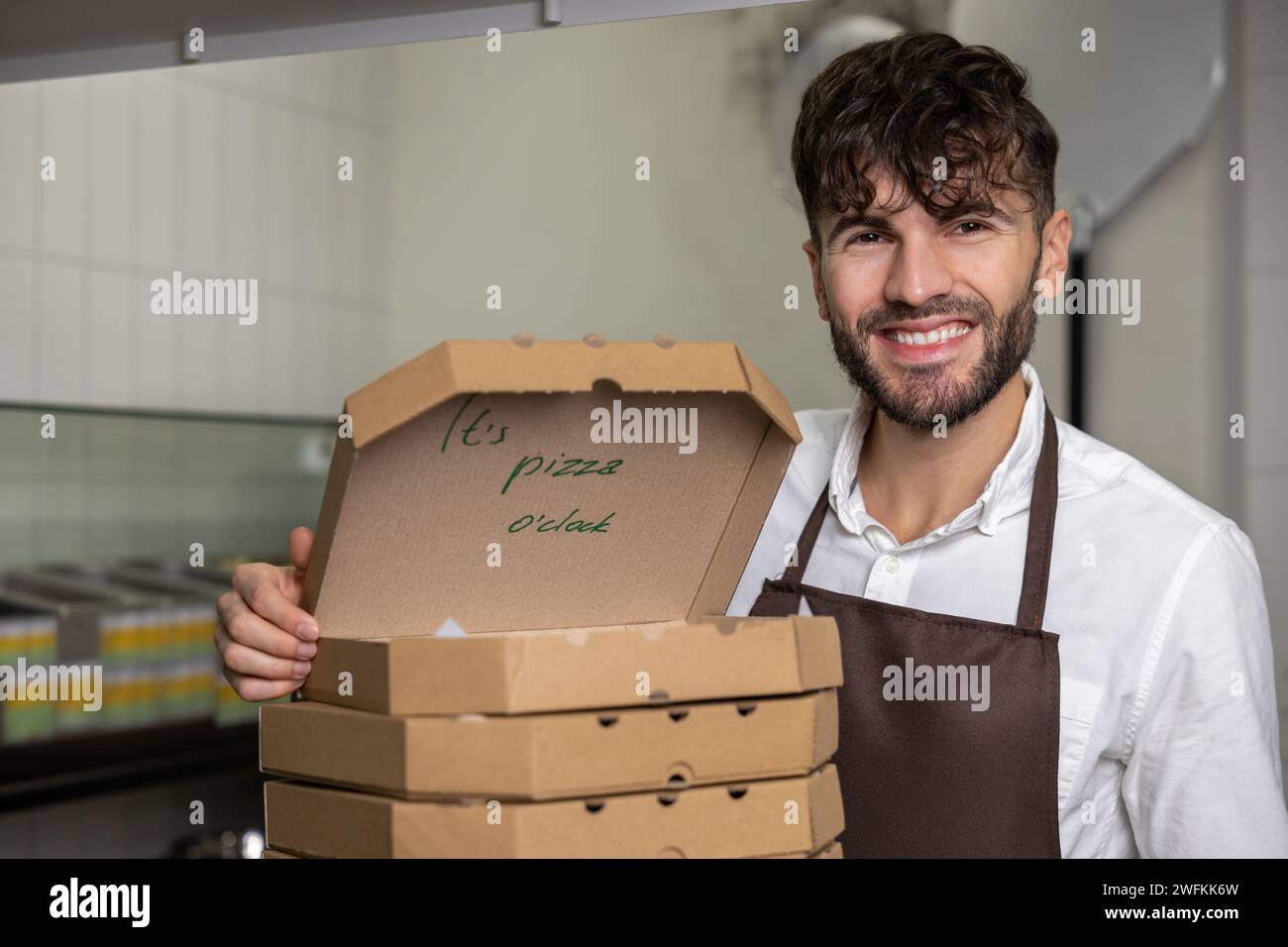 Male service man with many pizza boxes in pizzeria Stock Photo - Alamy