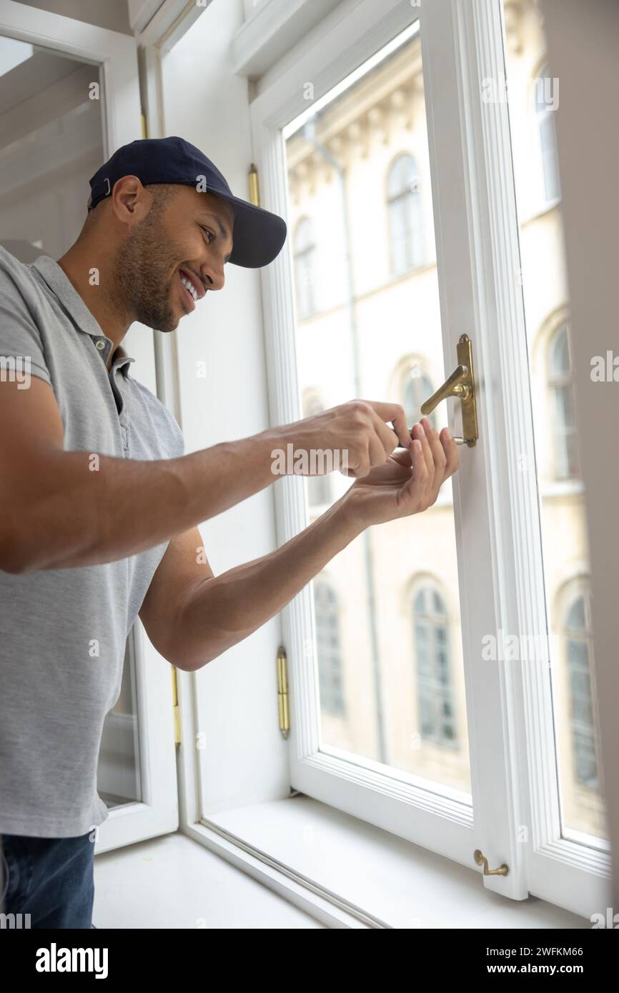 Adult man fixing window at home doing work about the house Stock Photo ...