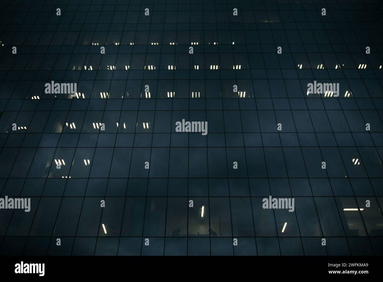 Workers can be seen in an office building late at night in Rio de ...