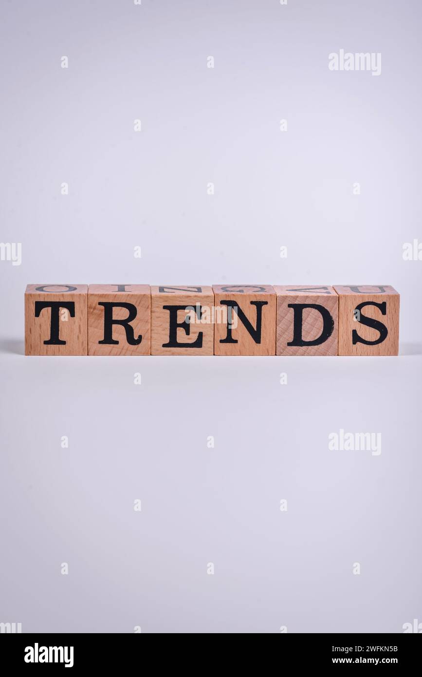 The inscription Trend made of wooden cubes on a plain background. Can ...