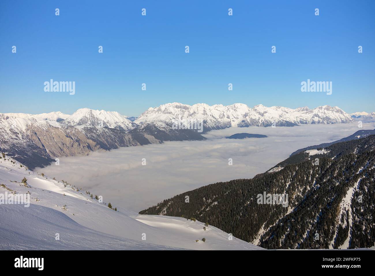 View from the Hochzeiger. The Inn valley looks like a see of fog. Snow ...