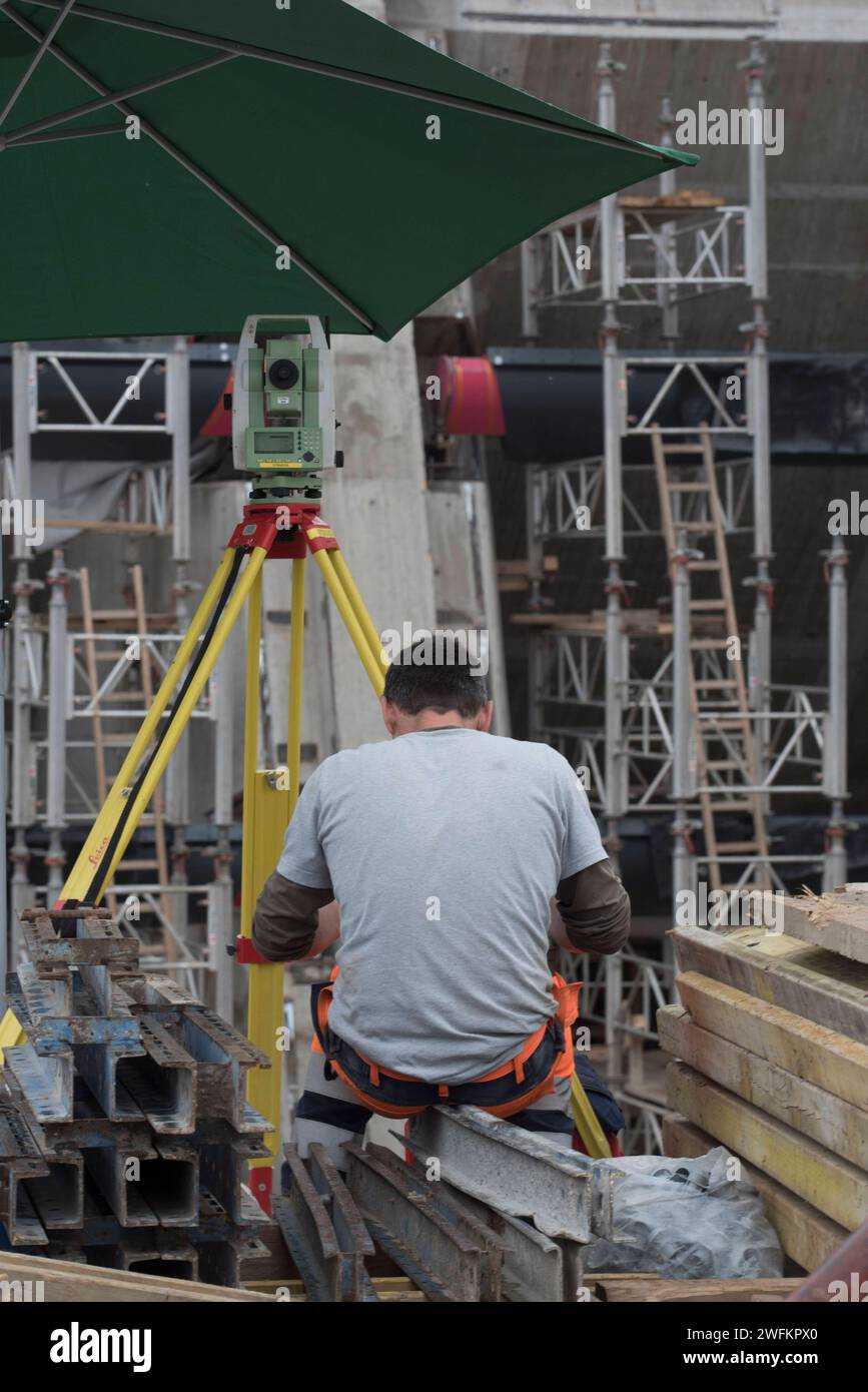 surveying by a land surveyor with measure instruments in geodesy ...