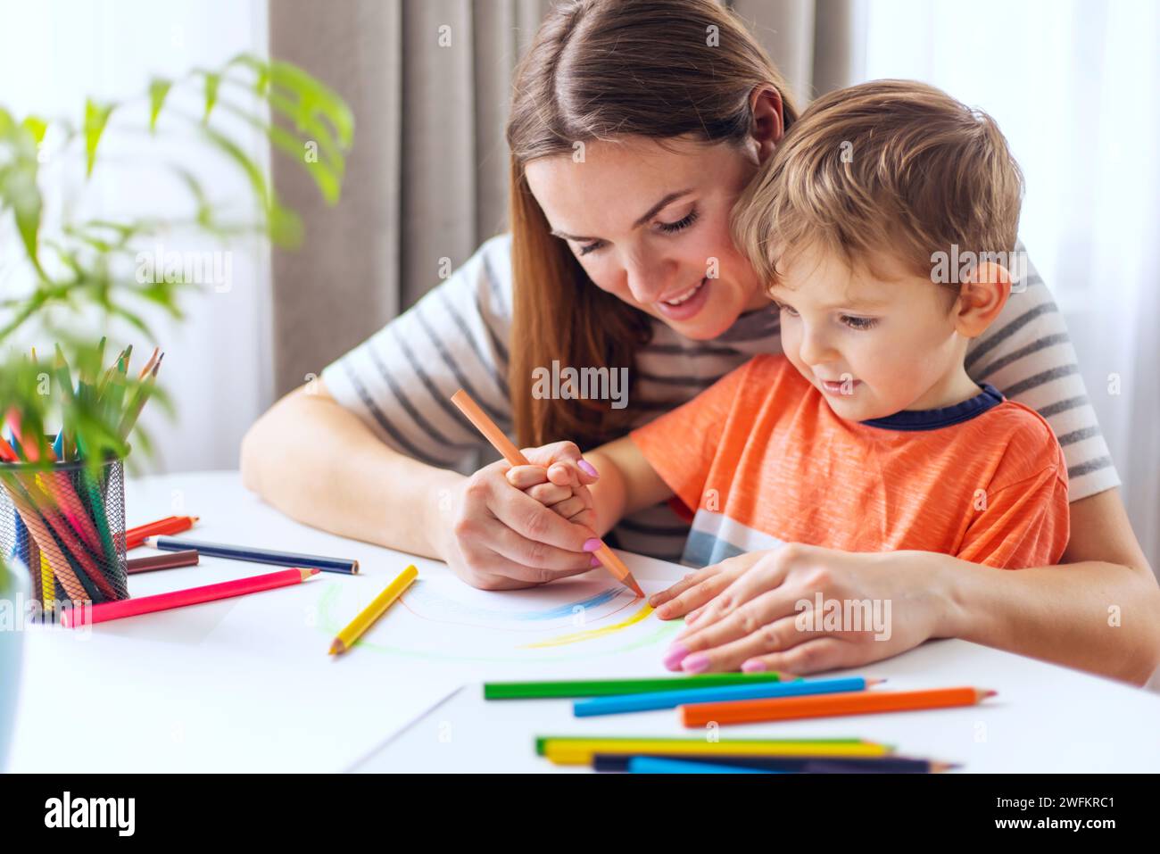 Young Mother Helps Son with Creative Drawing Stock Photo - Alamy