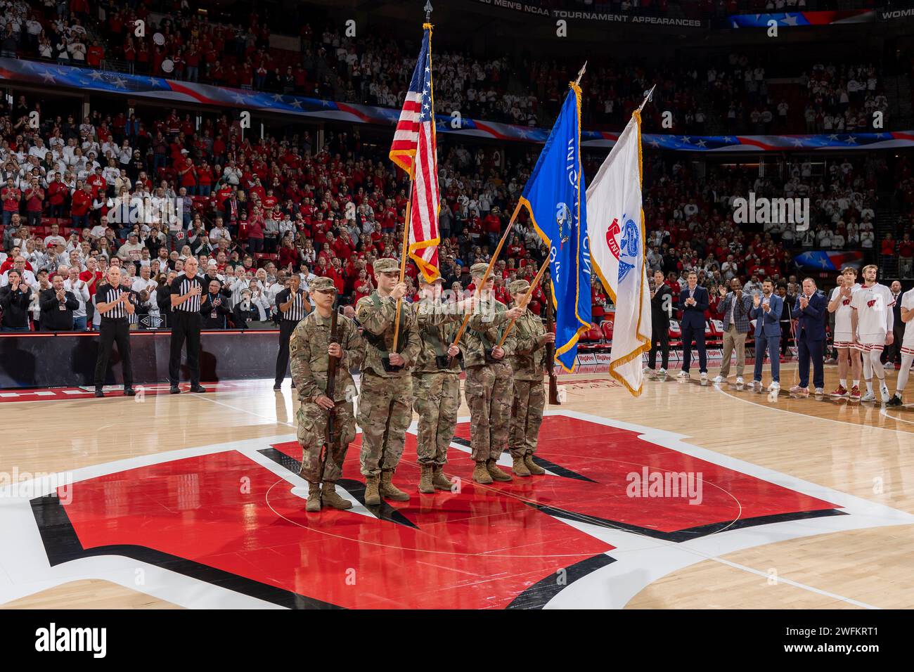 The University of Wisconsin Army ROTC Color Guard present the flags ...