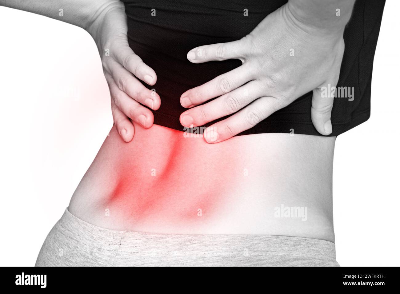 Young girl holding her back because of back pain, sitting on a white ...