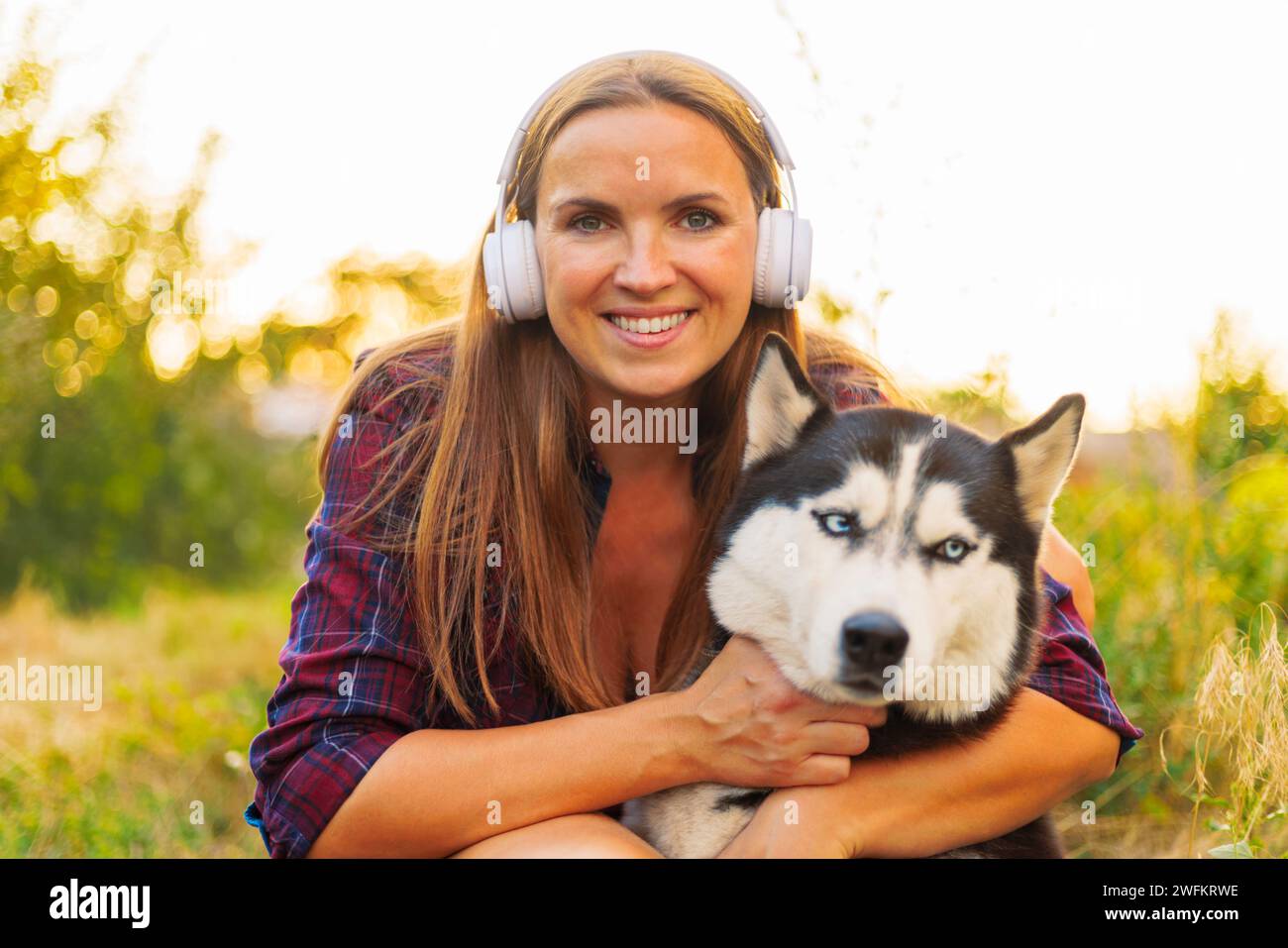 Smiling Woman Hugging Her Husky Dog Outdoors Stock Photo - Alamy Smiling Woman Hugging Her Husky Dog Outdoors Stock Photo - Alamy