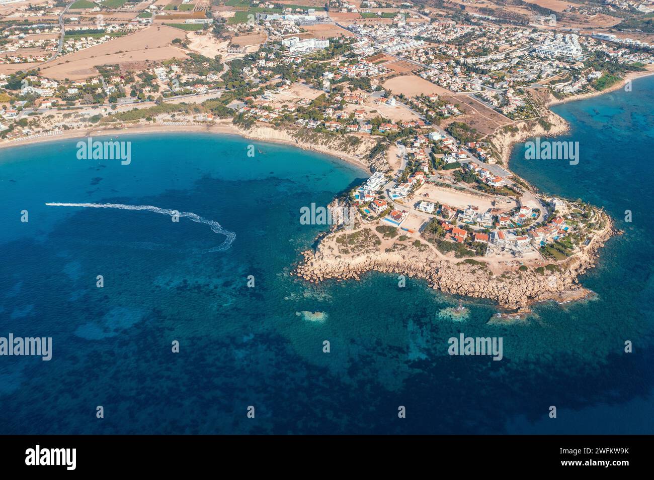 Aerial top down view of picturesque village nestled by Cyprus coastline ...