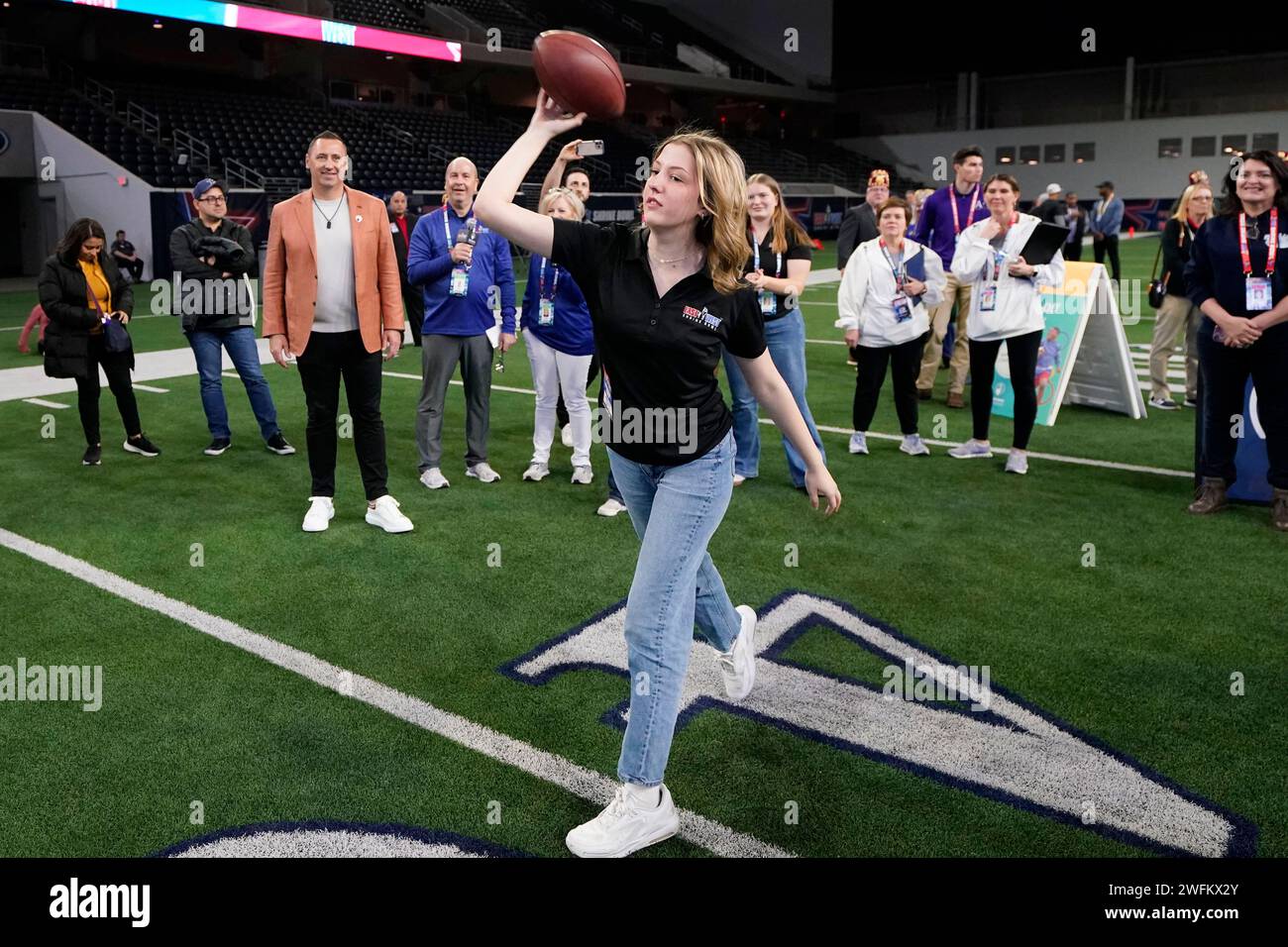 Alyssa Jones attempts to throw a football into a target net as Texas ...
