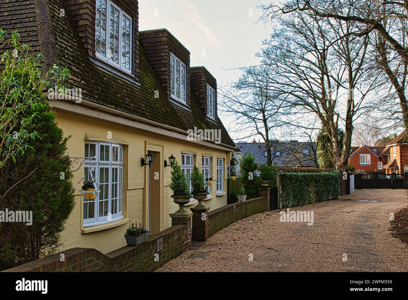 Charming traditional English cottage with yellow facade, white windows ...