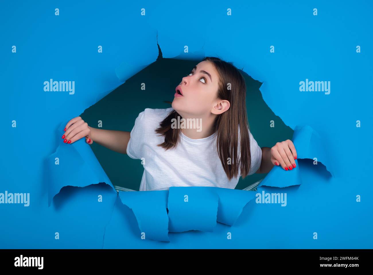 Shocked face of woman shouting WOW, isolated on studio background with ...