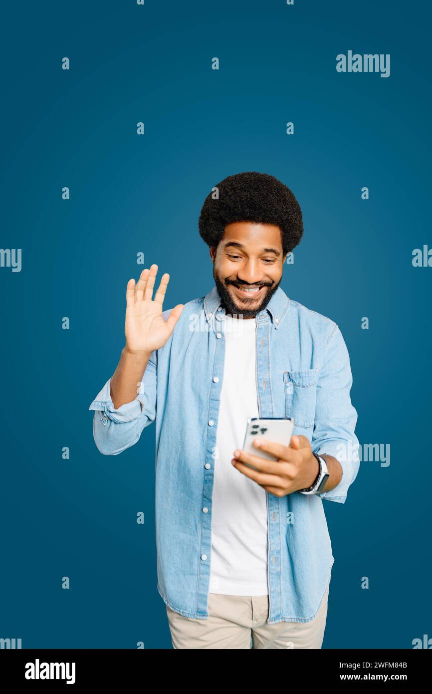 Friendly and cheerful Brazilian man smiling and waving at his ...