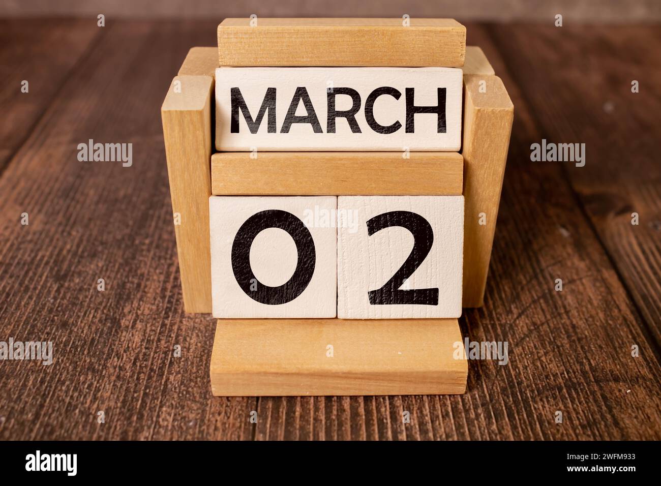 March 02 calendar date text on white wooden block with stationeries on ...