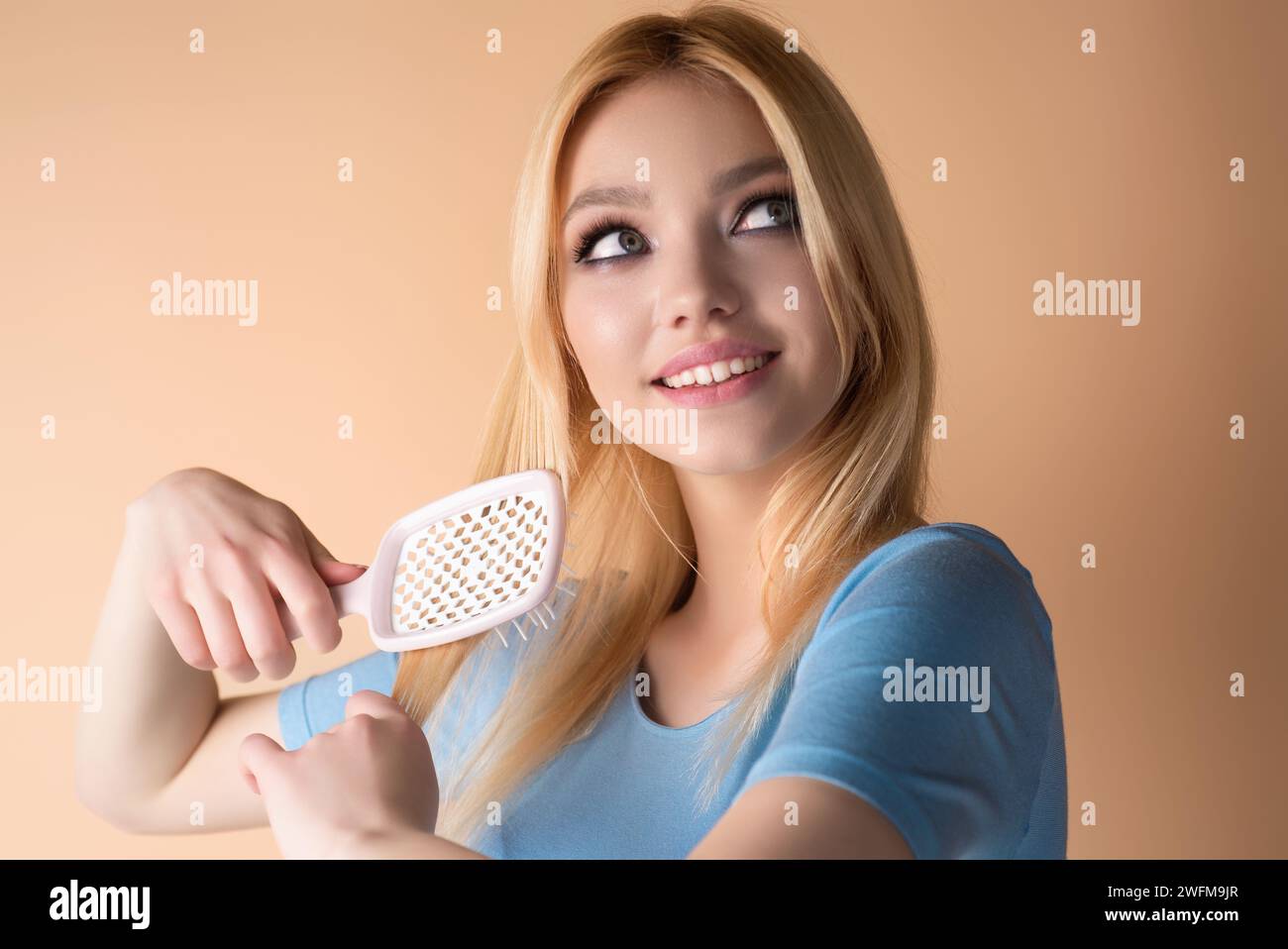 Woman combing her hair. Cares about a healthy and clean hair. Beauty ...