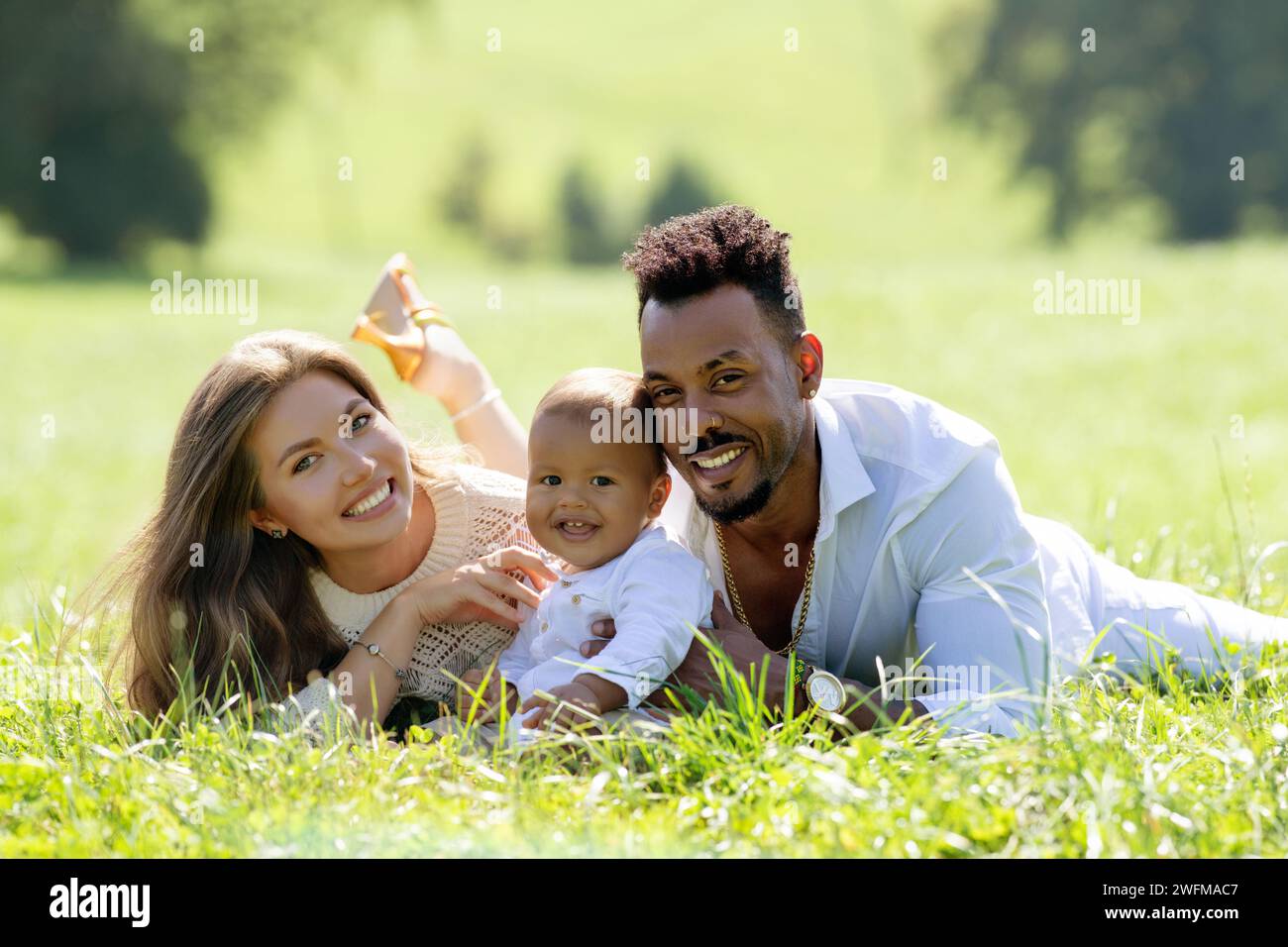 Multiethnic parents and mixed race baby in park. Multiethnic family ...