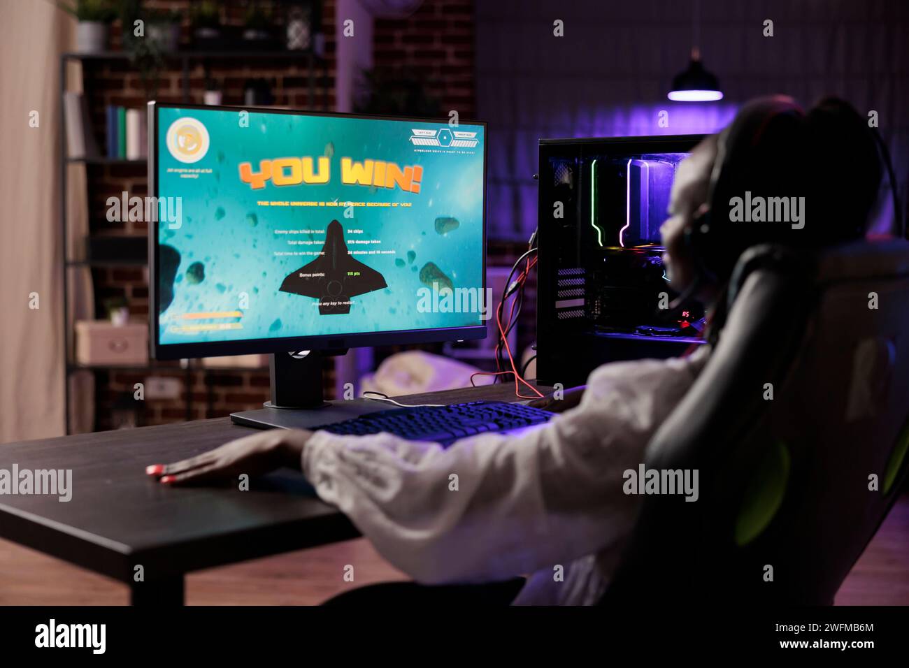 Gamer celebrating winning online multiplayer SF videogame matchup ...