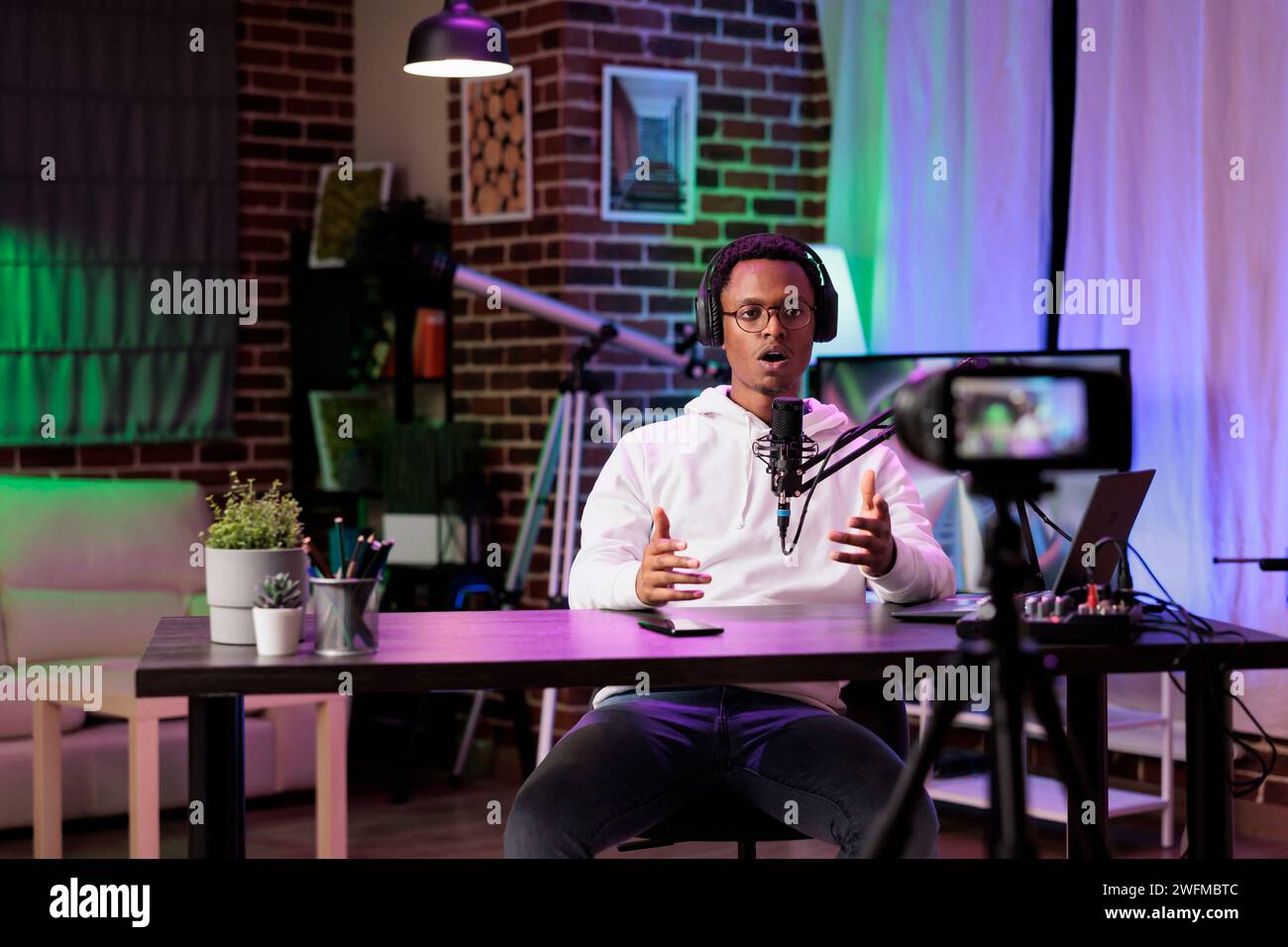 Vlogger recording internet show using modern camera, talking about ...