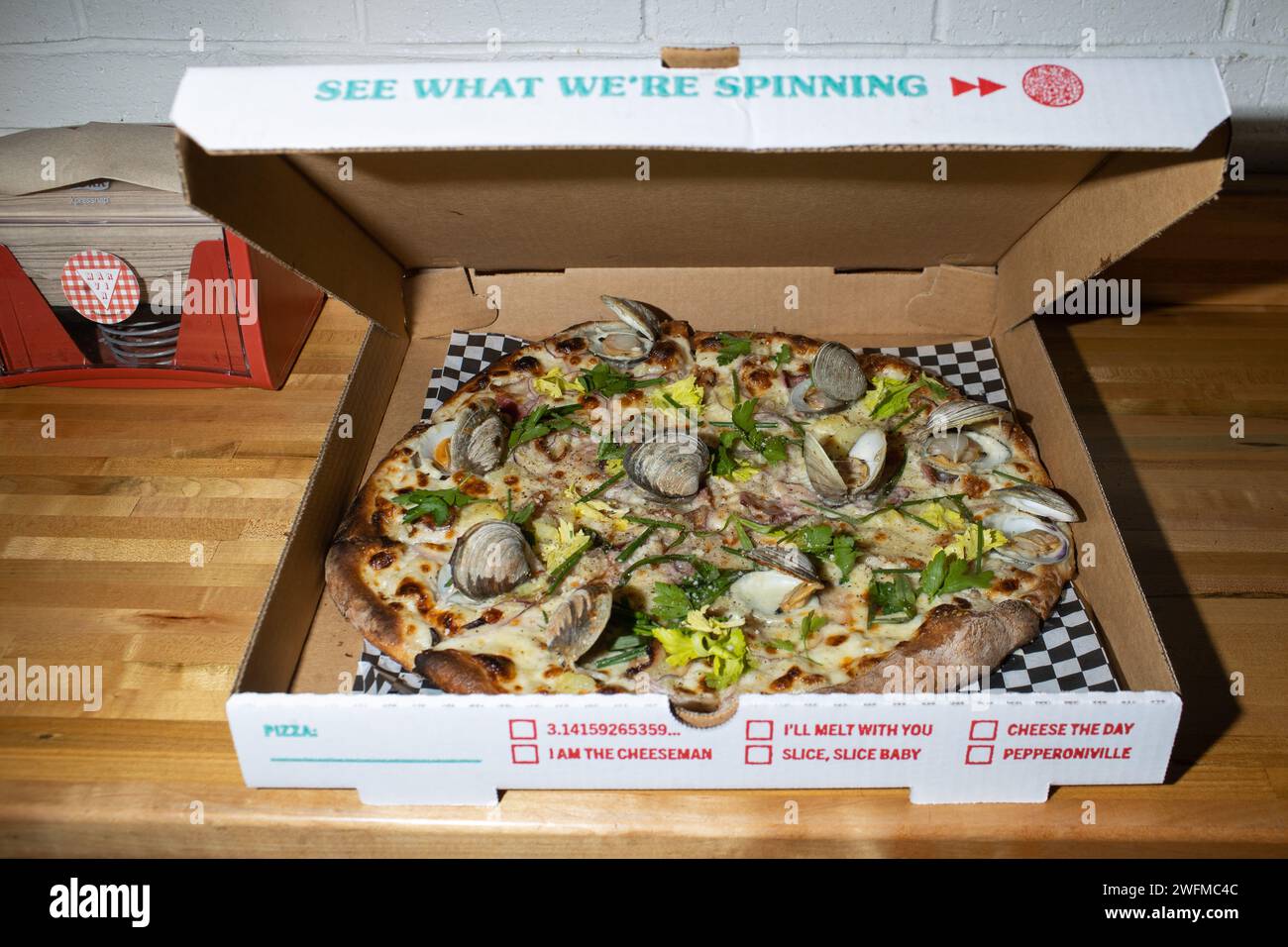 The ‘Chowdah Pie’ which features clams, potatoes and bacon sits on a ...