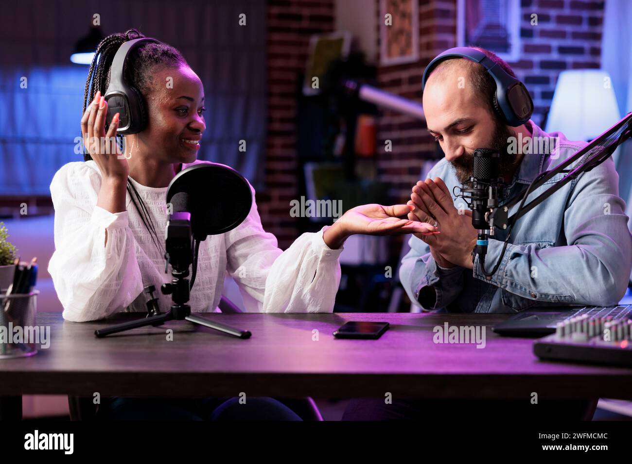 Cohosts presenting religion podcast in professional studio, teaching ...